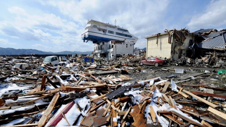 A sightseeing boat hurled onto a two-story building at Otsuchi, Iwate ...