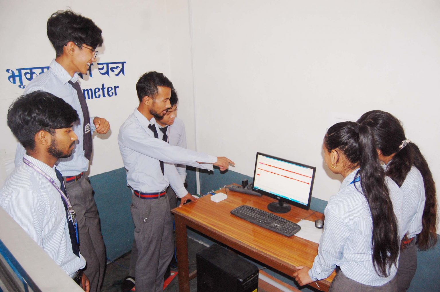 Students in Nepal observe waveforms recorded by the seismometer ...
