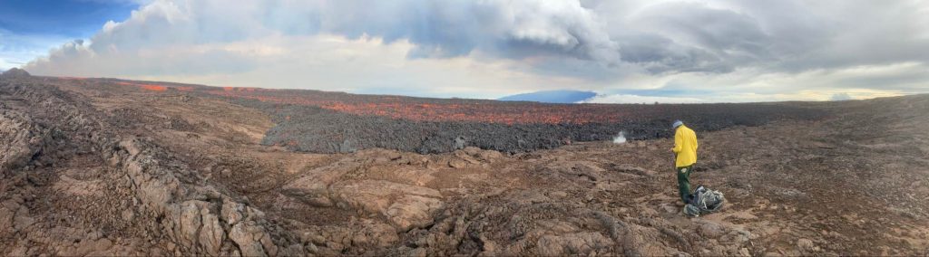 A scientist from the Hawaiian Volcano Observatory stands in front of ...