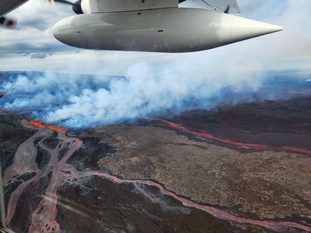 Aerial photos of lava flows moving downslope from fissures erupting on ...